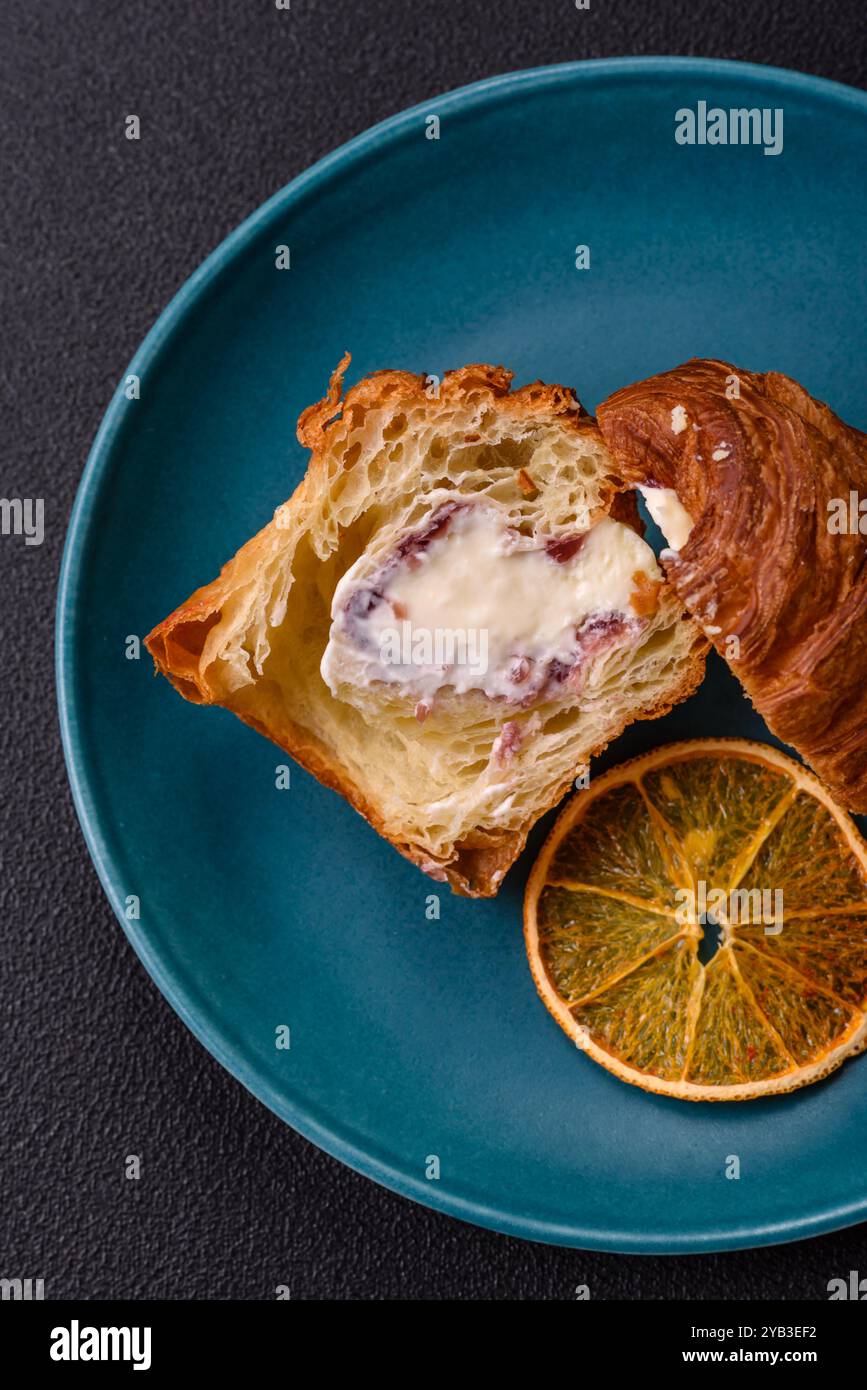 Sweet craffin made from puff pastry with Swiss meringue on a dark ...