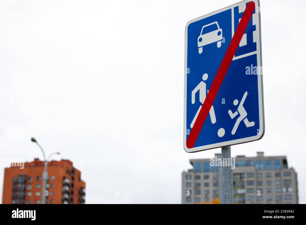 A blue and white street sign clearly depicting a red line crossing ...