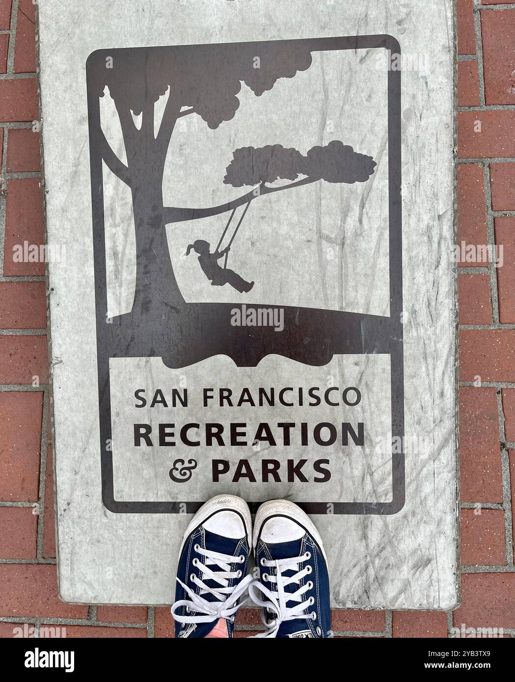 Sidewalk sign for San Francisco Recreation and parks with feet in ...