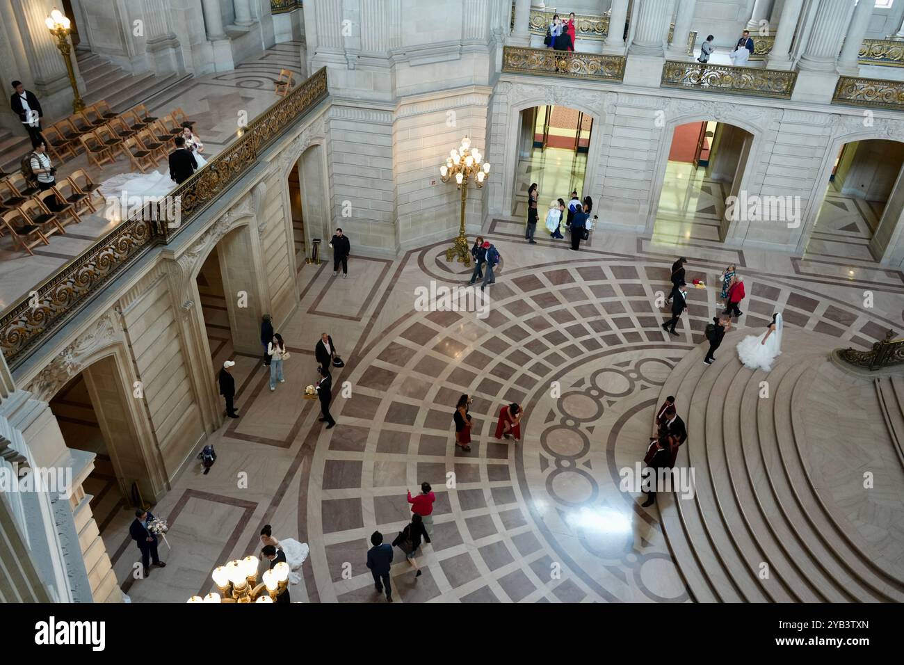 Multiple wedding groups inside San Fransisco City Hall Stock Photo - Alamy