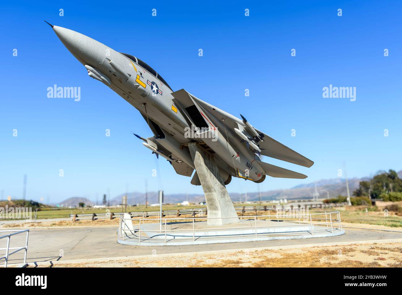 F-14 Tomcat fighter aircraft mounted on a pedestal, angled as if taking ...