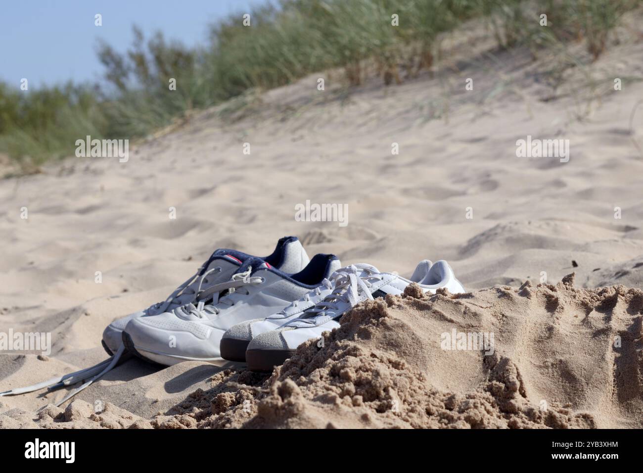 white human shoes in the beach sand Stock Photo - Alamy