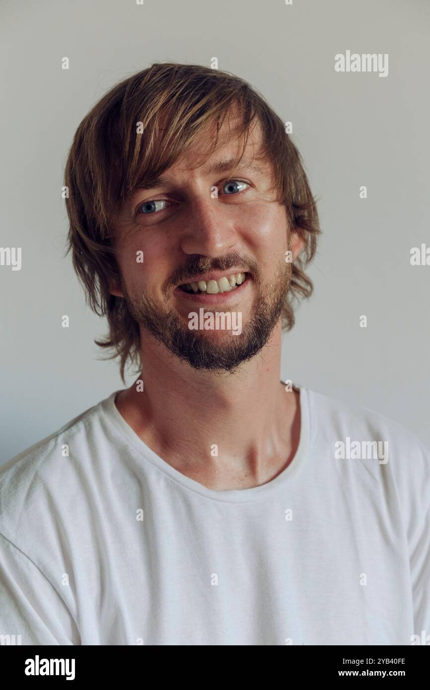 Portrait of smily cheerful man with long hair Stock Photo - Alamy