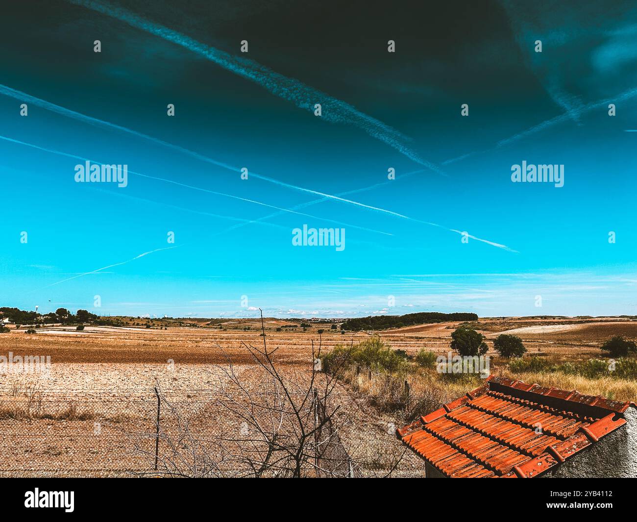 Ranch land. A house in a countryside, a terracotta roof and field, blue ...