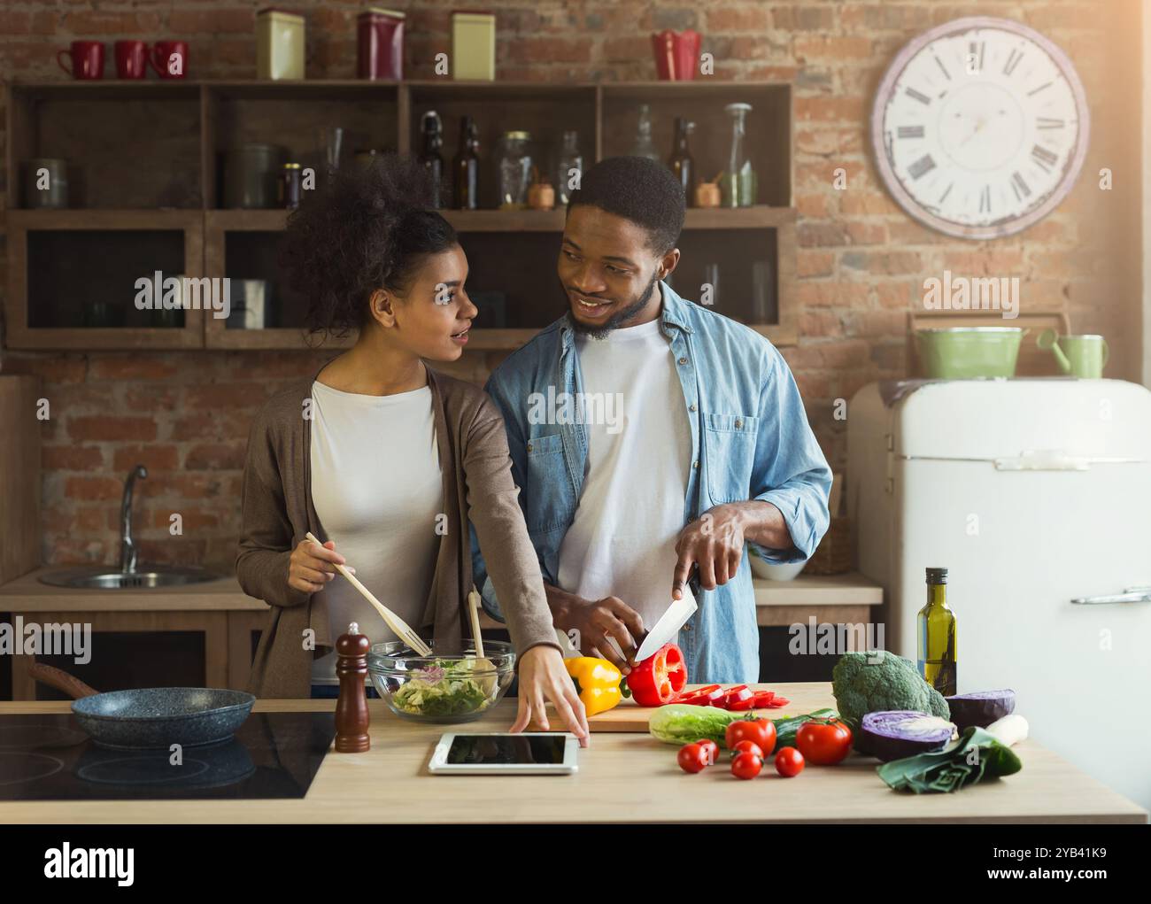 Happy black couple cooking healthy food together Stock Photo - Alamy