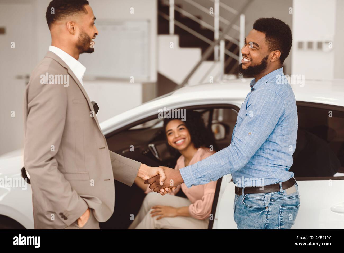 Happy customers shaking hands car hi-res stock photography and images ...