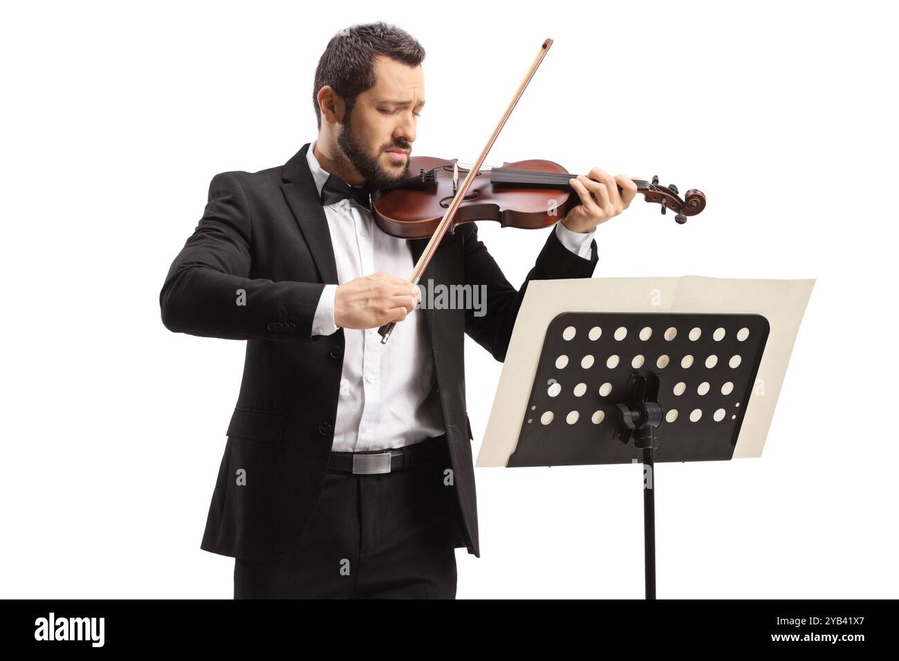 Violinist playing a violin in front of a sheet music stand isolated on ...