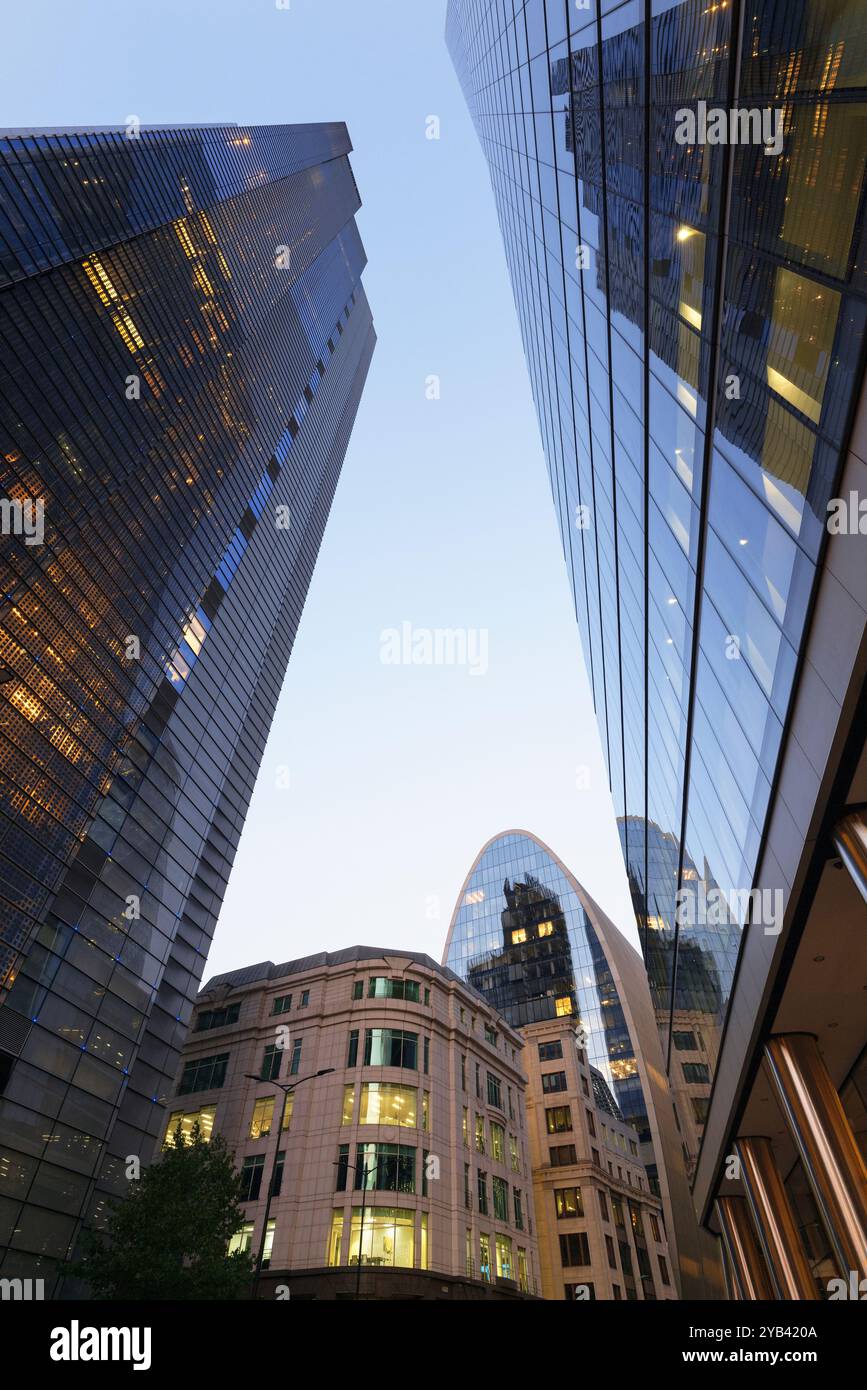 Modern financial buildings in City of London illuminated at twilight ...