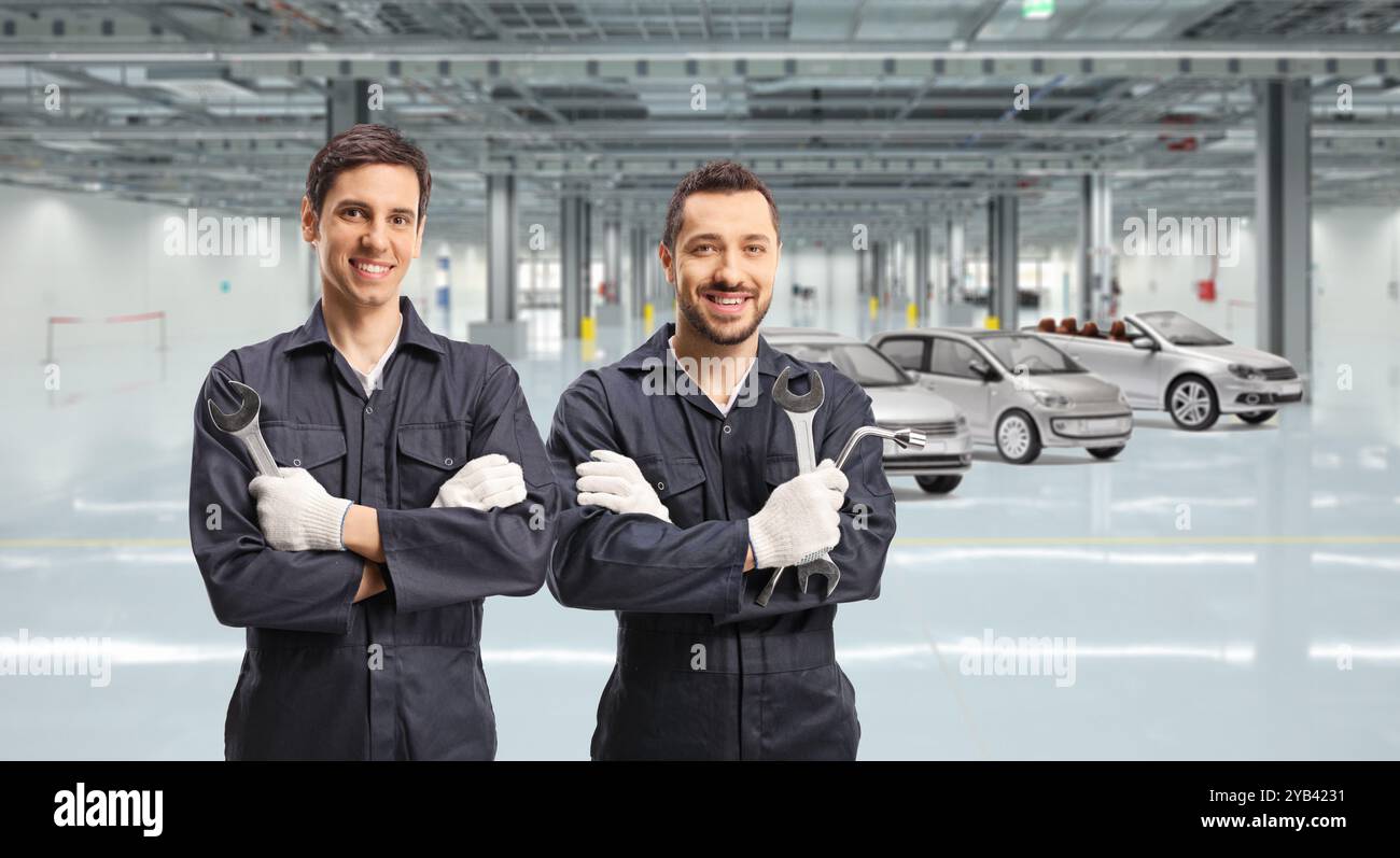 Car factory workers in uniforms holding tools Stock Photo - Alamy