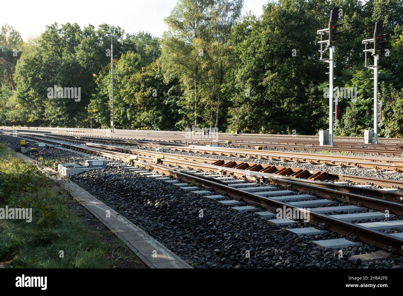 Two railroad tracks run parallel to each other and lead through an ... Two railroad tracks run parallel to each other and lead through an ...