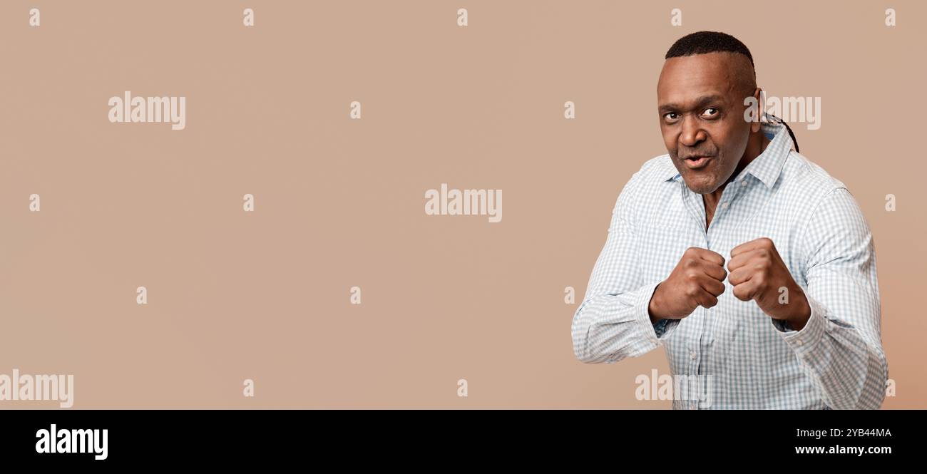 Mature african american man with fight gesture Stock Photo - Alamy