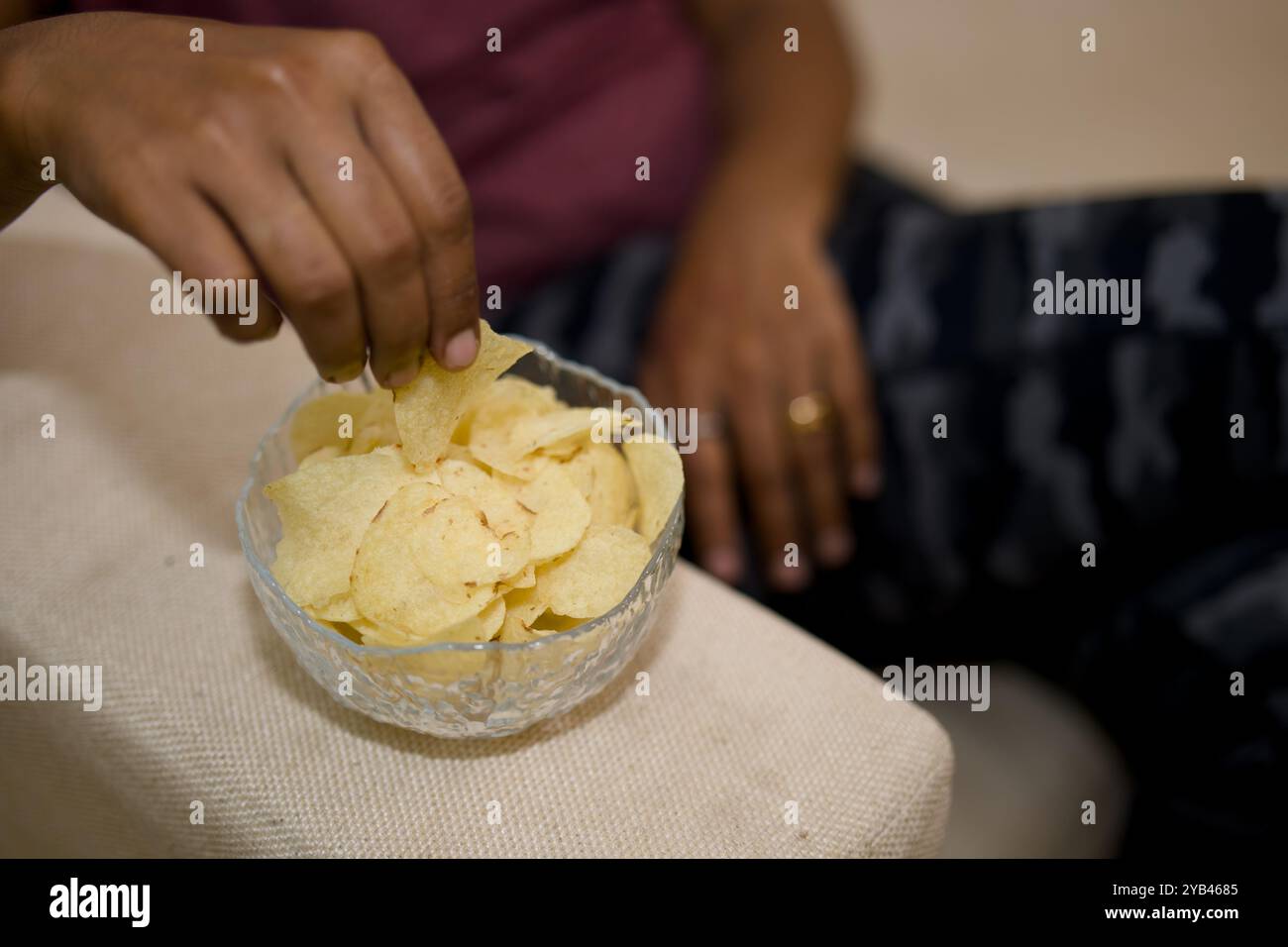 Hand grabbing chips in hi-res stock photography and images - Alamy