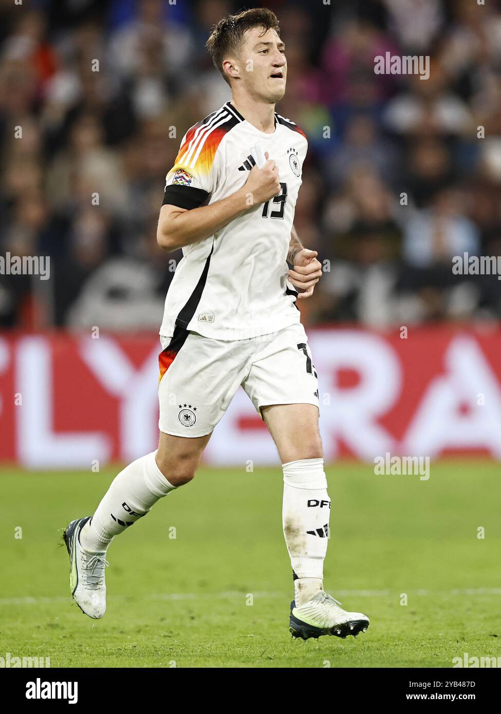 MUNCHEN - Angelo Stiller of Germany holding a bill with the tactics he ...