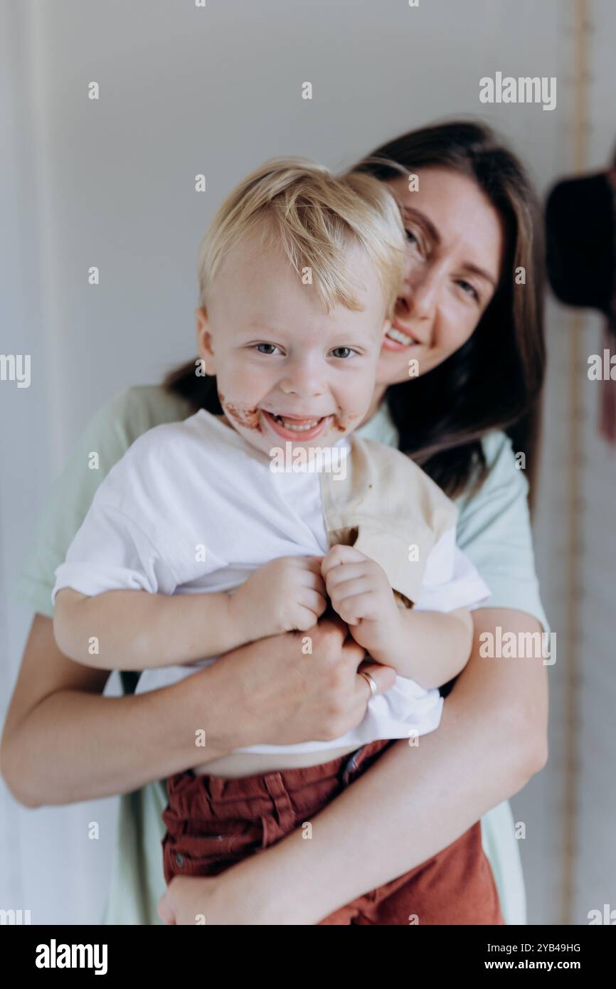 Mother and son smiling, sharing a joyful moment indoors, creating a ...