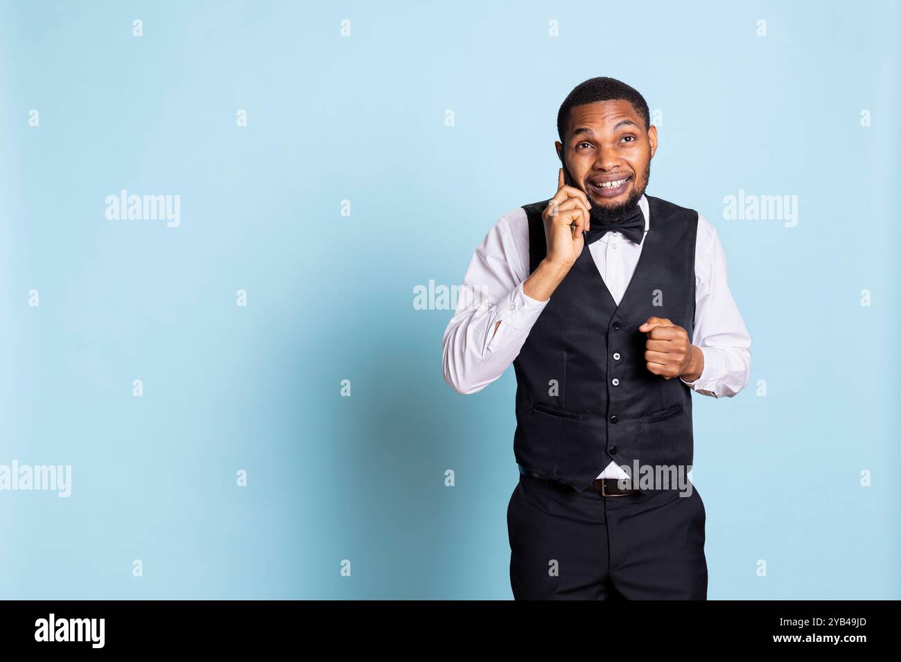 Professional front desk personnel chatting on phone call with guests ...