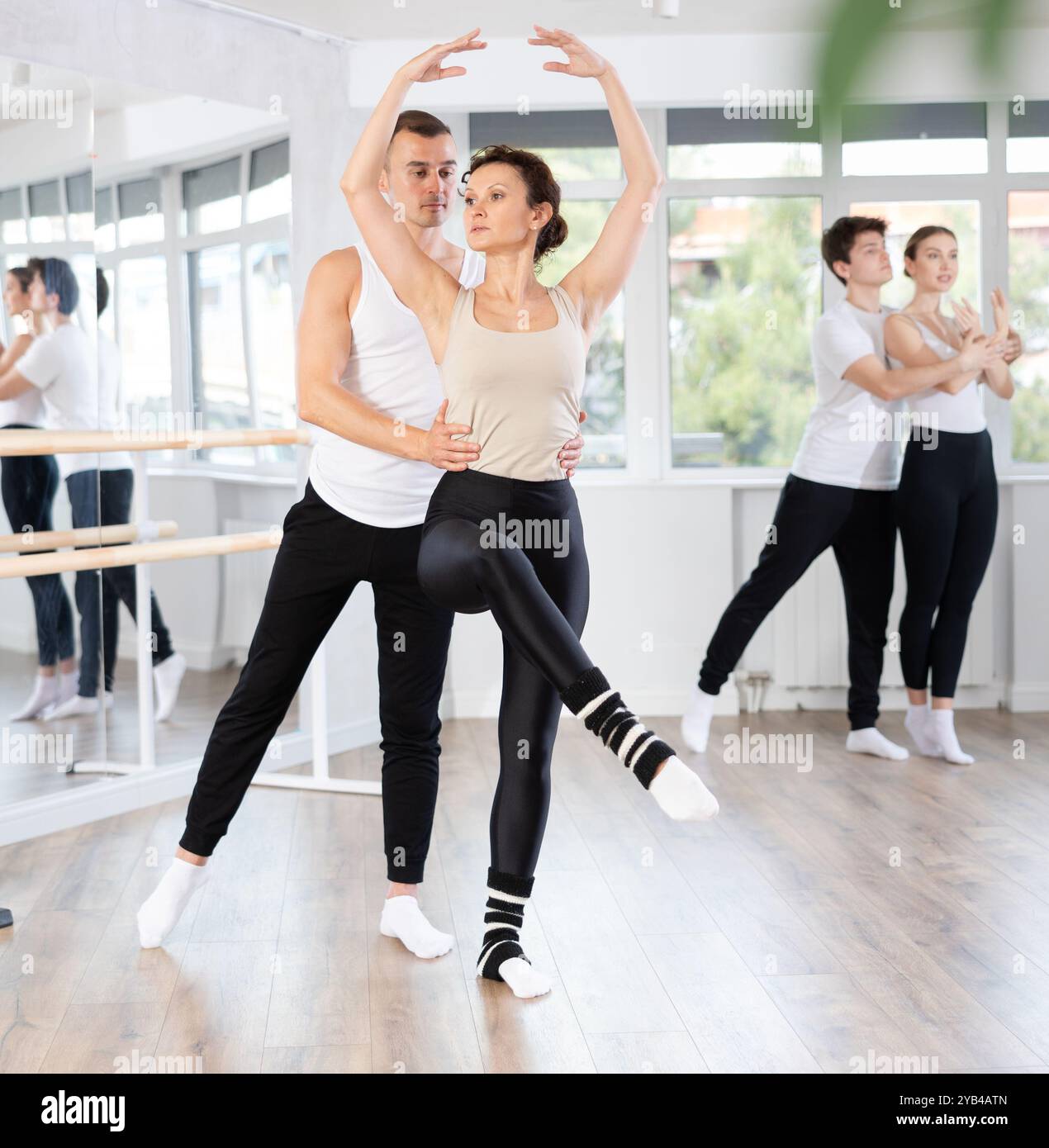 Smiling young man and female partner in black and white clothing with ...