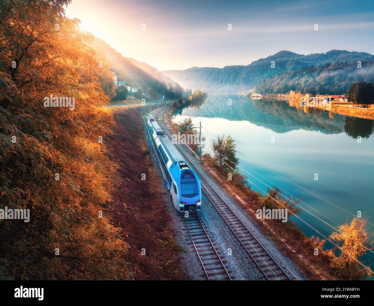 Aerial view of high speed train moving near lake in mountains Stock ...