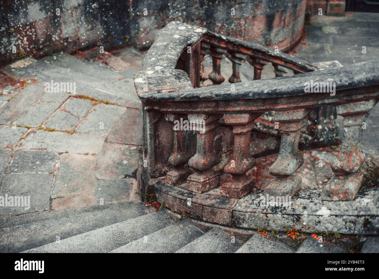 A weathered stone staircase with a balustrade featuring ornate, eroded ...