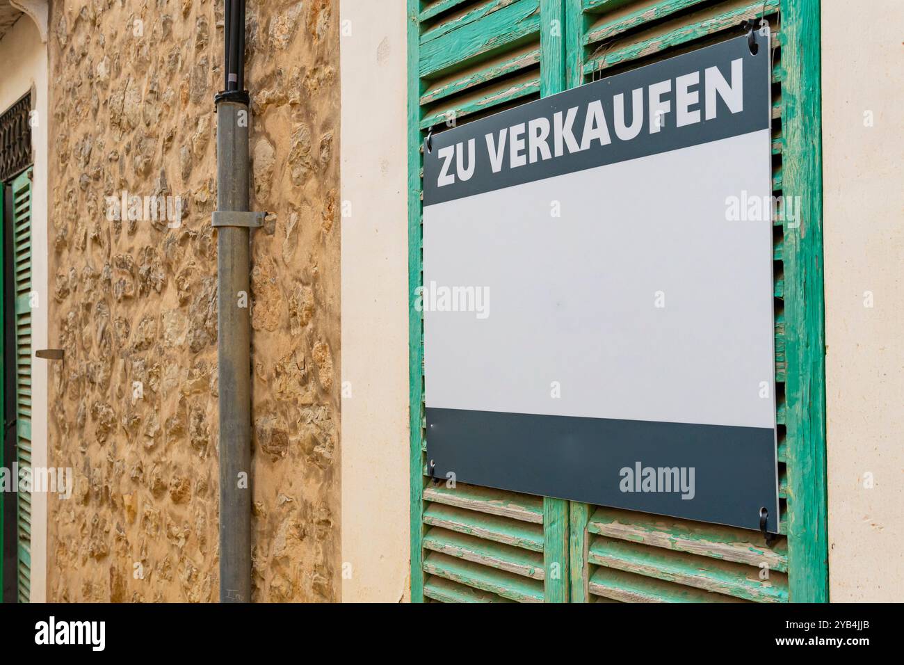 For sale sign written in German on the facade of a historic building on ...