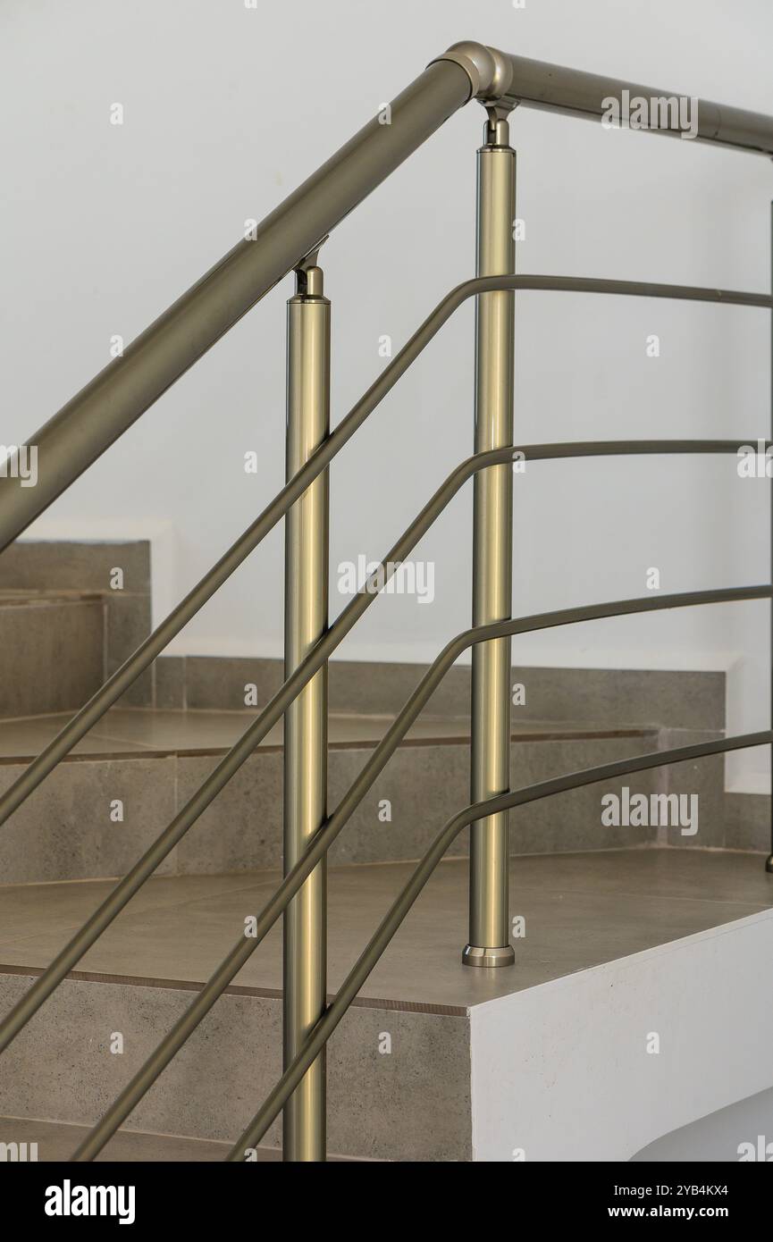 The sleek, modern railing complements the minimalist design of the ...