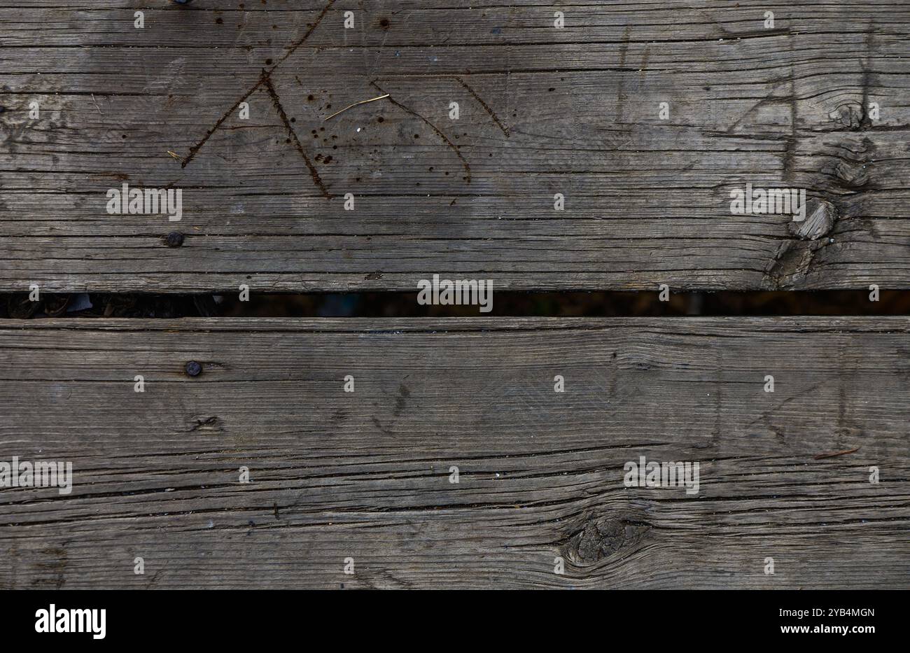 The surface features an array of weathered wooden planks, revealing ...