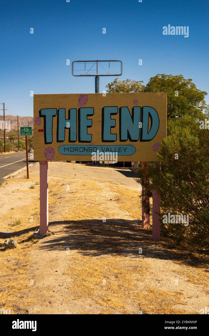 An odd scene with The End sign in front of a tall empty sign in Morongo ...