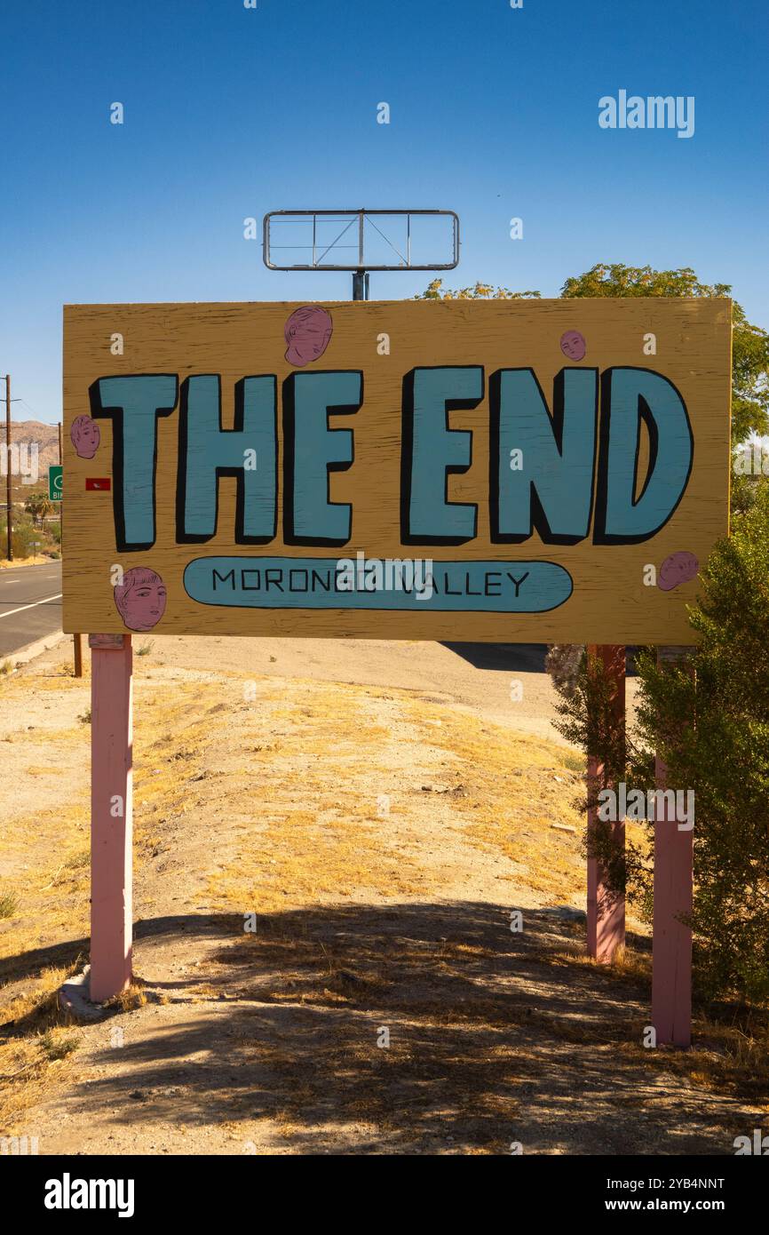 An odd scene with The End sign in front of a tall empty sign in Morongo ...