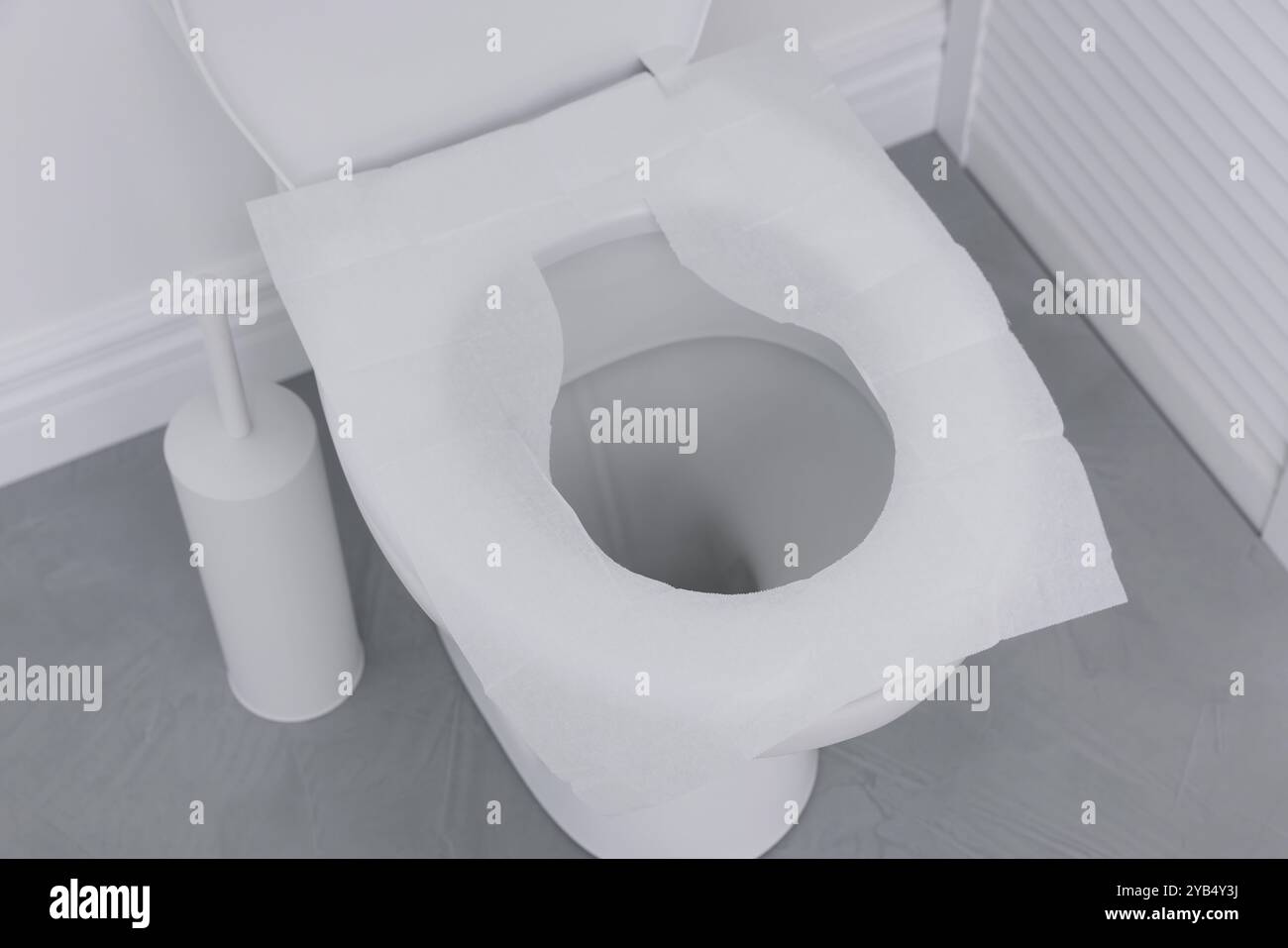 Toilet seat with paper tissues in bathroom Stock Photo - Alamy