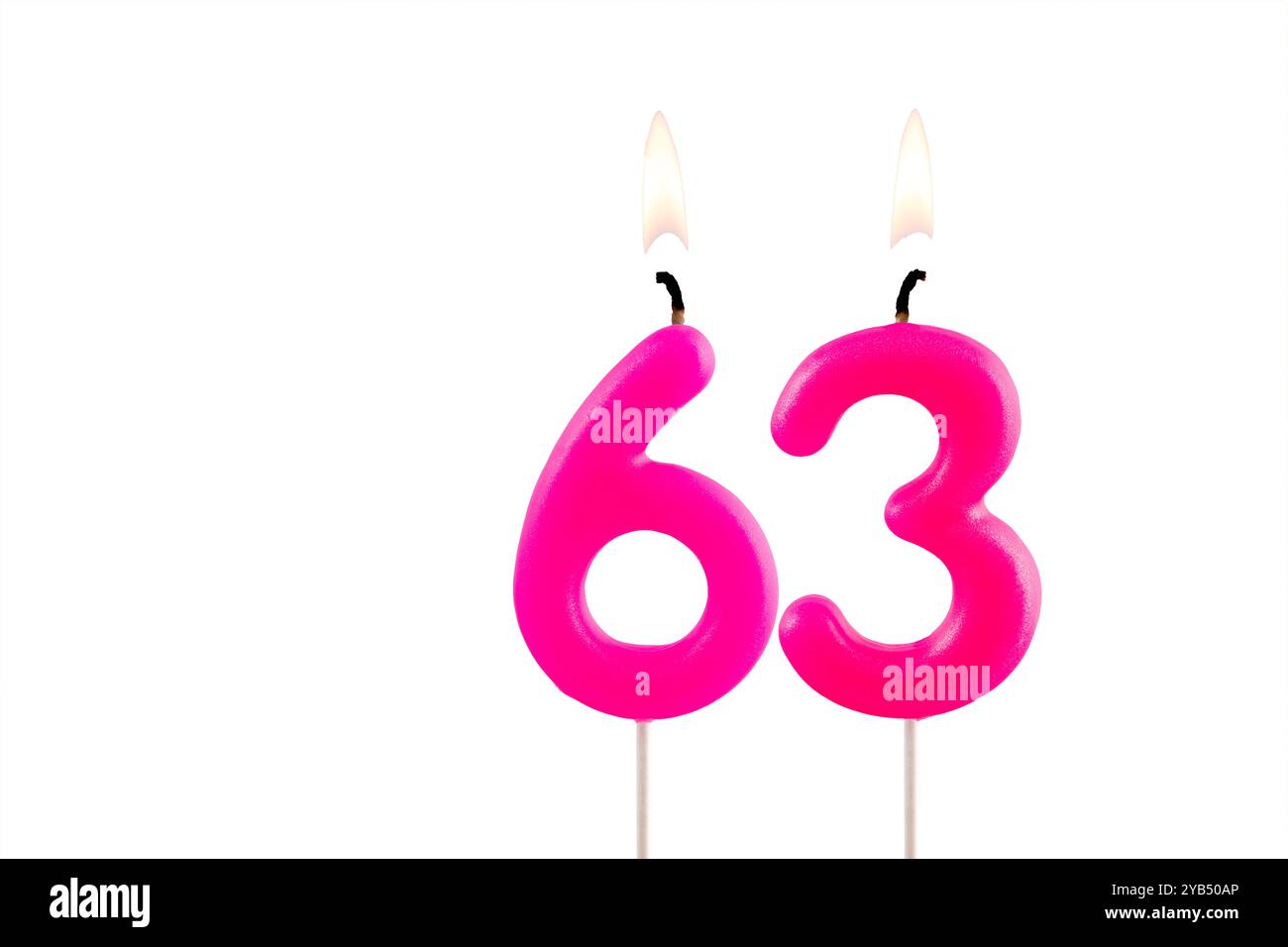 Pink number 63 birthday candle on white background Stock Photo - Alamy