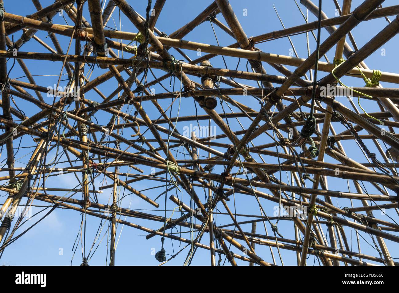 View through a complex bamboo installation into the blue sky, bamboo ...