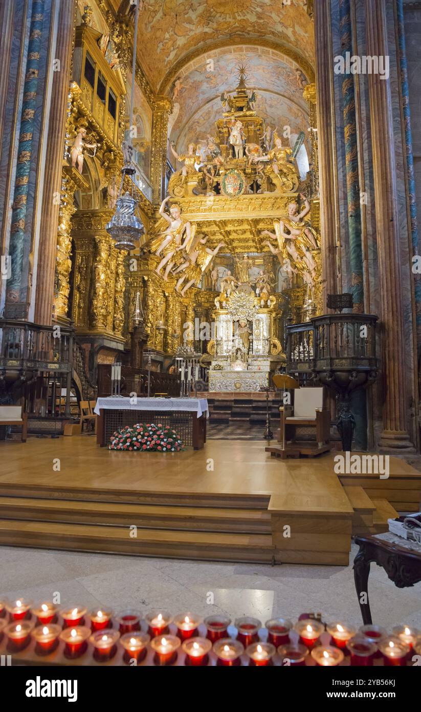 Baroque church interior with golden decorations, altar and burning ...