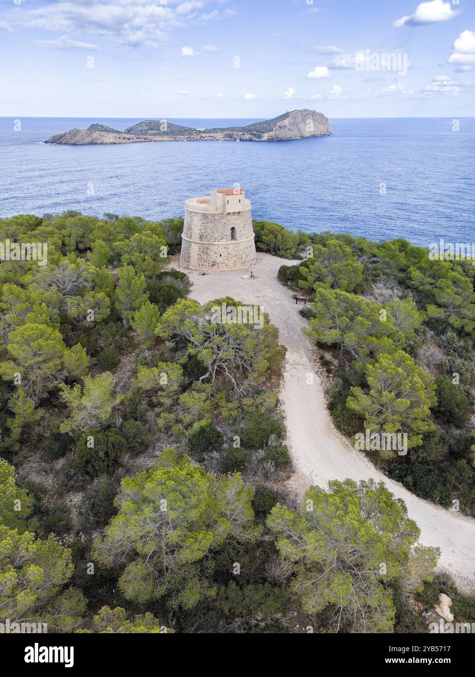 Historic defence defence tower Torre d'en Valls on a tree-covered hill ...