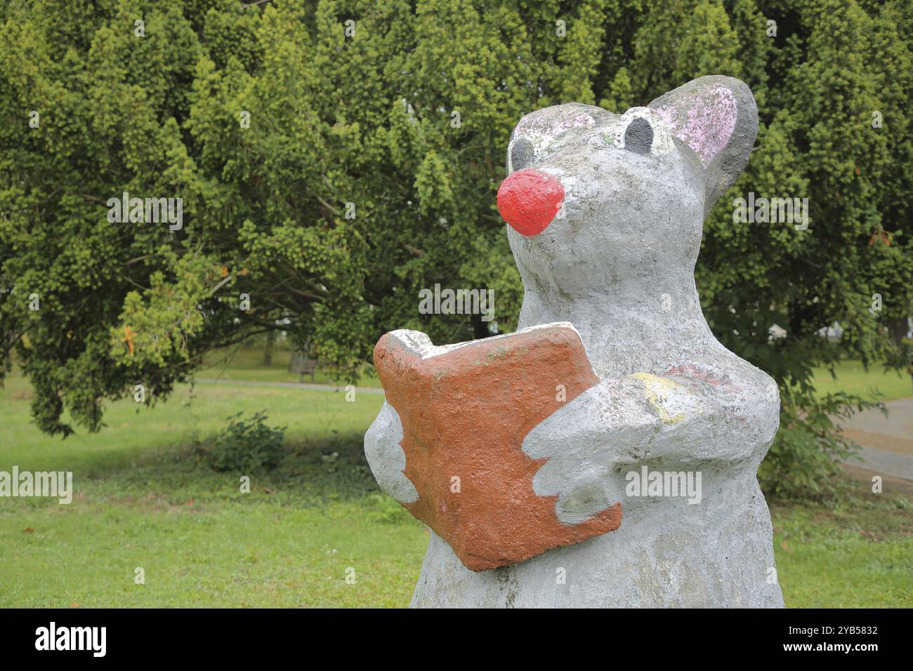 Mouse figure reading book with red nose in park, bookworm, bookworm ...
