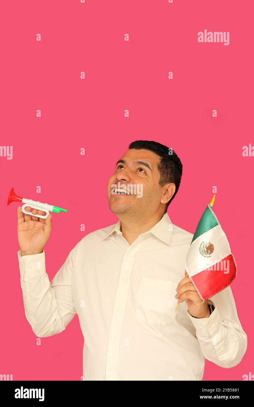 Dark-skinned Mexican adult man with Mexico flag and toy trumpet ...