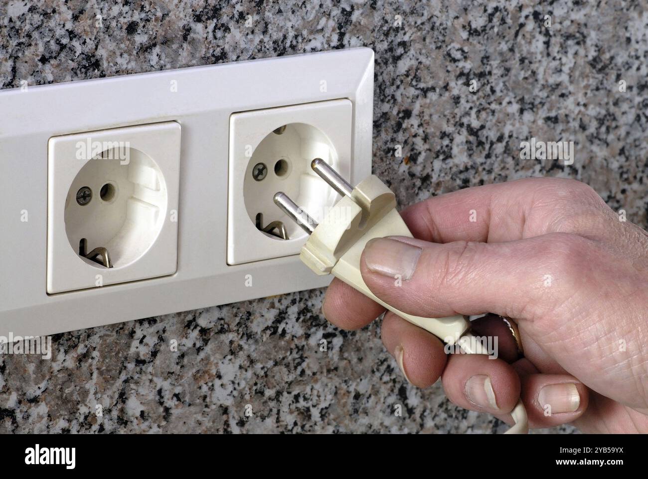 Hand with plugs and sockets Stock Photo - Alamy