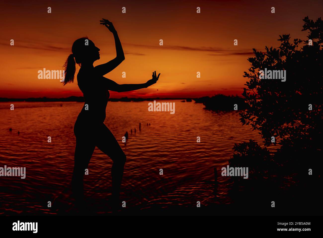 A gorgeous latin model poses as the sun rises over the Gulf of Mexico ...