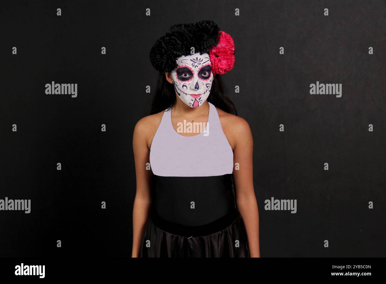 Mexican teenage woman with skull or catrina makeup and flower crown ...