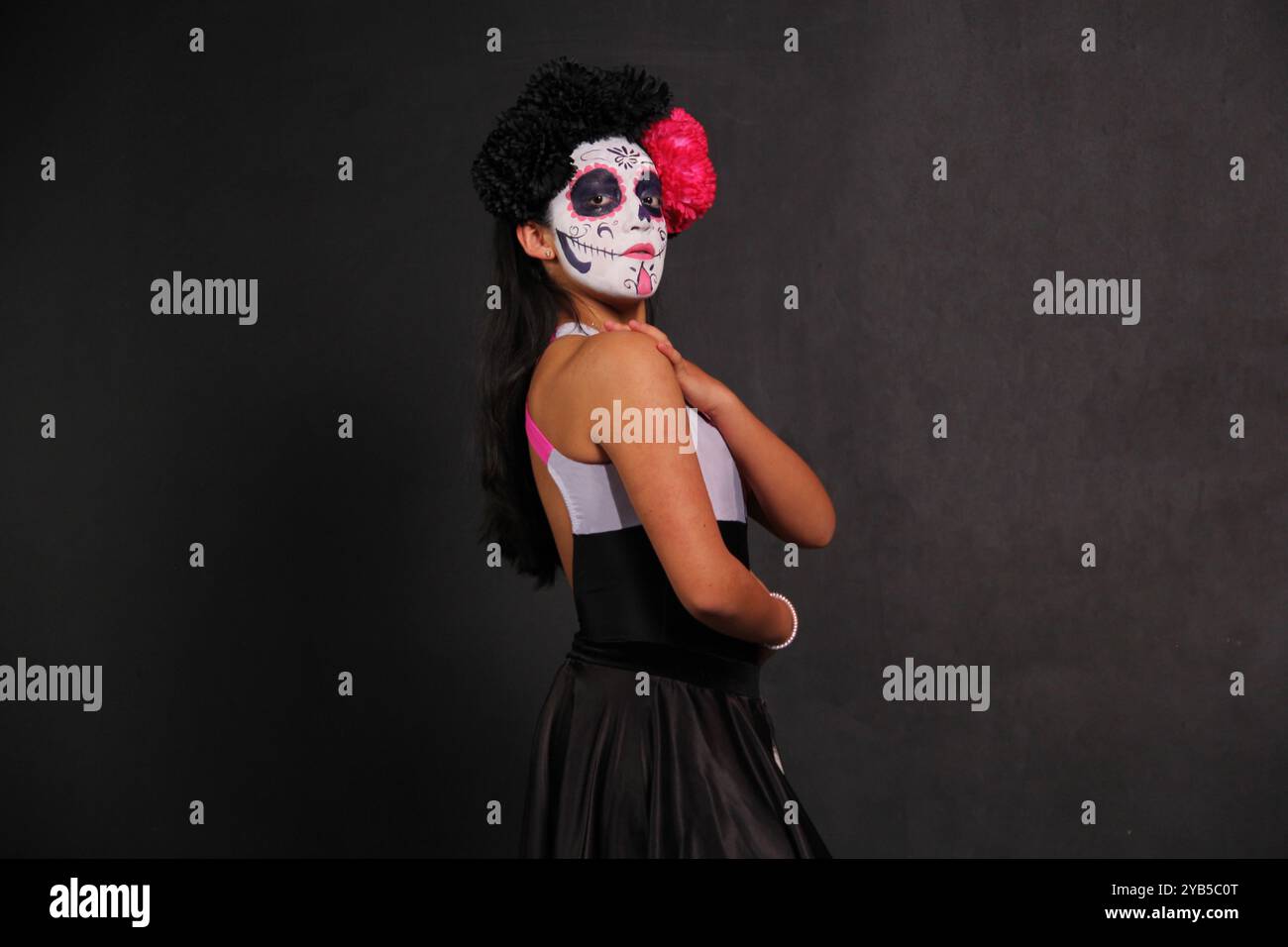 Mexican teenage woman with skull or catrina makeup and flower crown ...