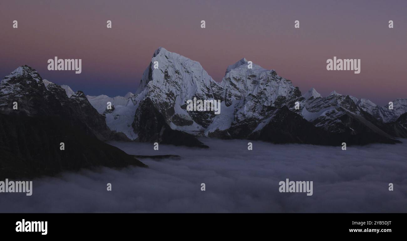 Nightfall in the Himalayas. Pink sky over Mount Cholatse and Tobuche ...