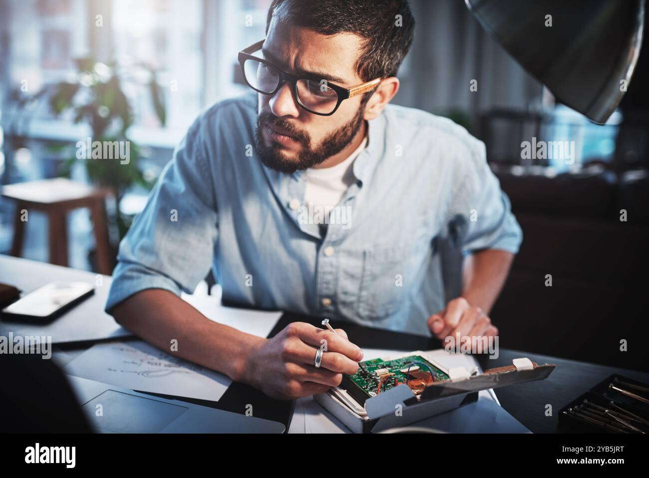 Remote work from home, engineering and man with robotics, improvement ...