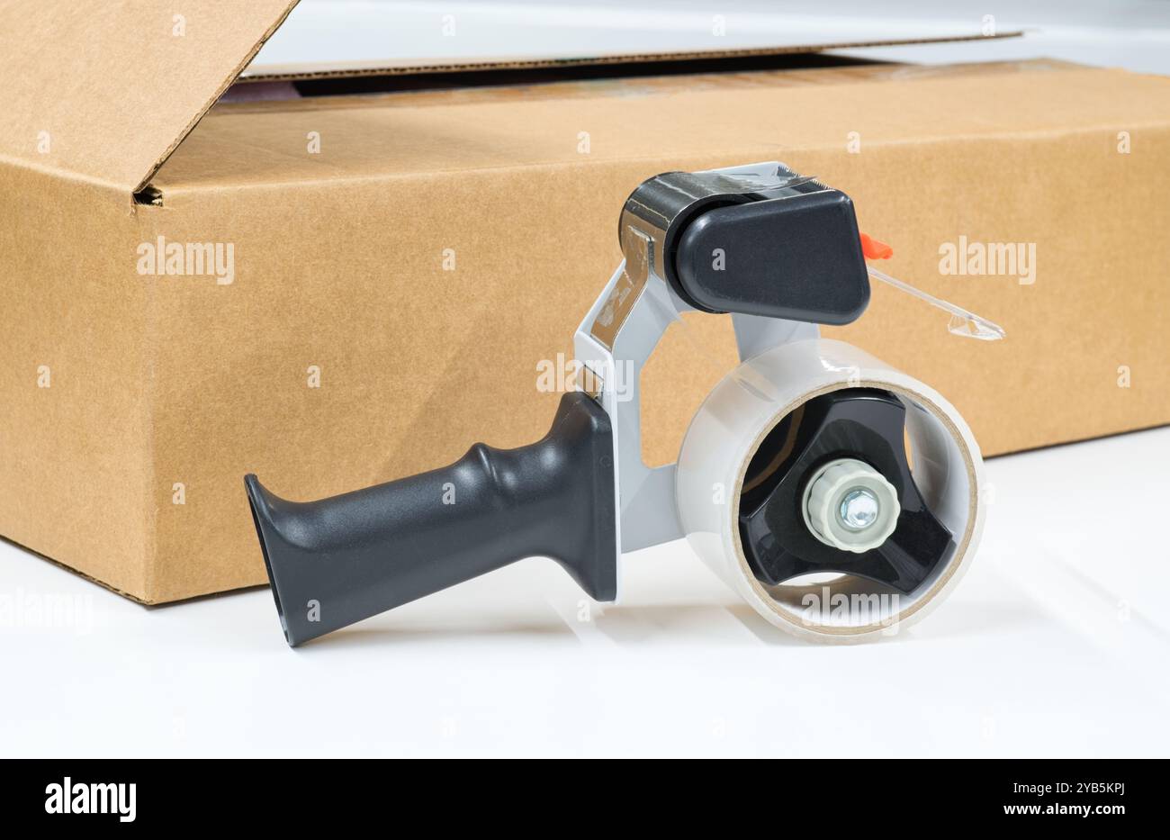 Tape gun dispenser and cardboard box shipping concept with copy space ...