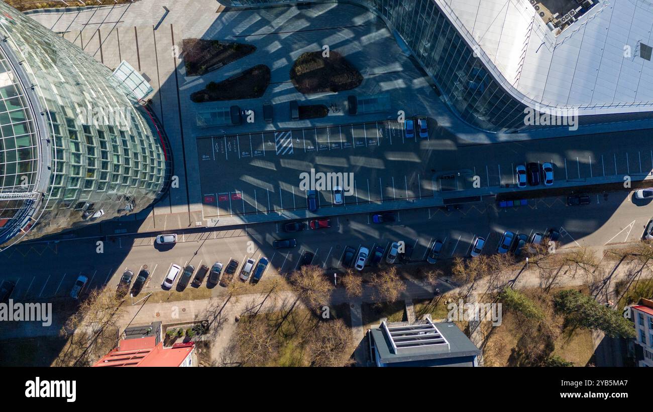 Aerial view of a modern urban area with a parking lot, cars, buildings ...
