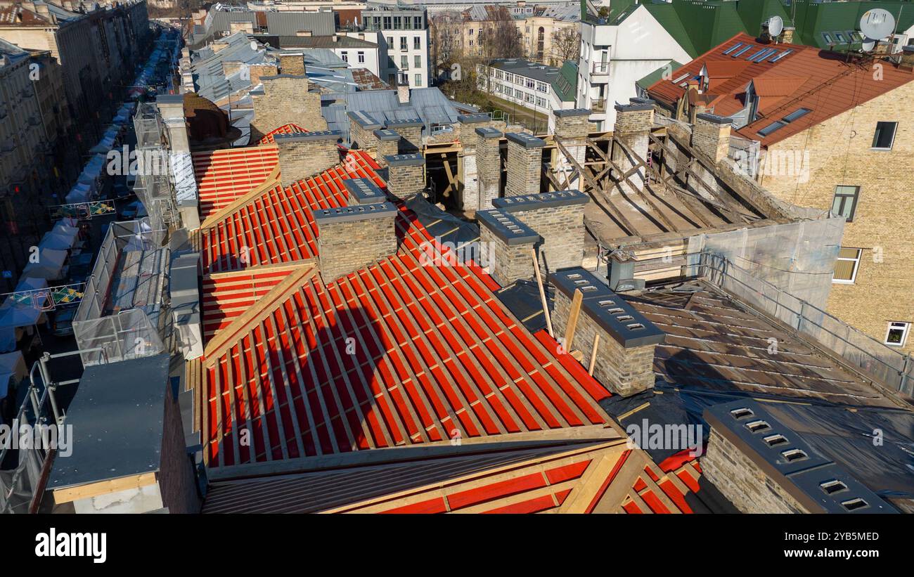 Aerial view of a rooftop renovation site with red roof and stone ...
