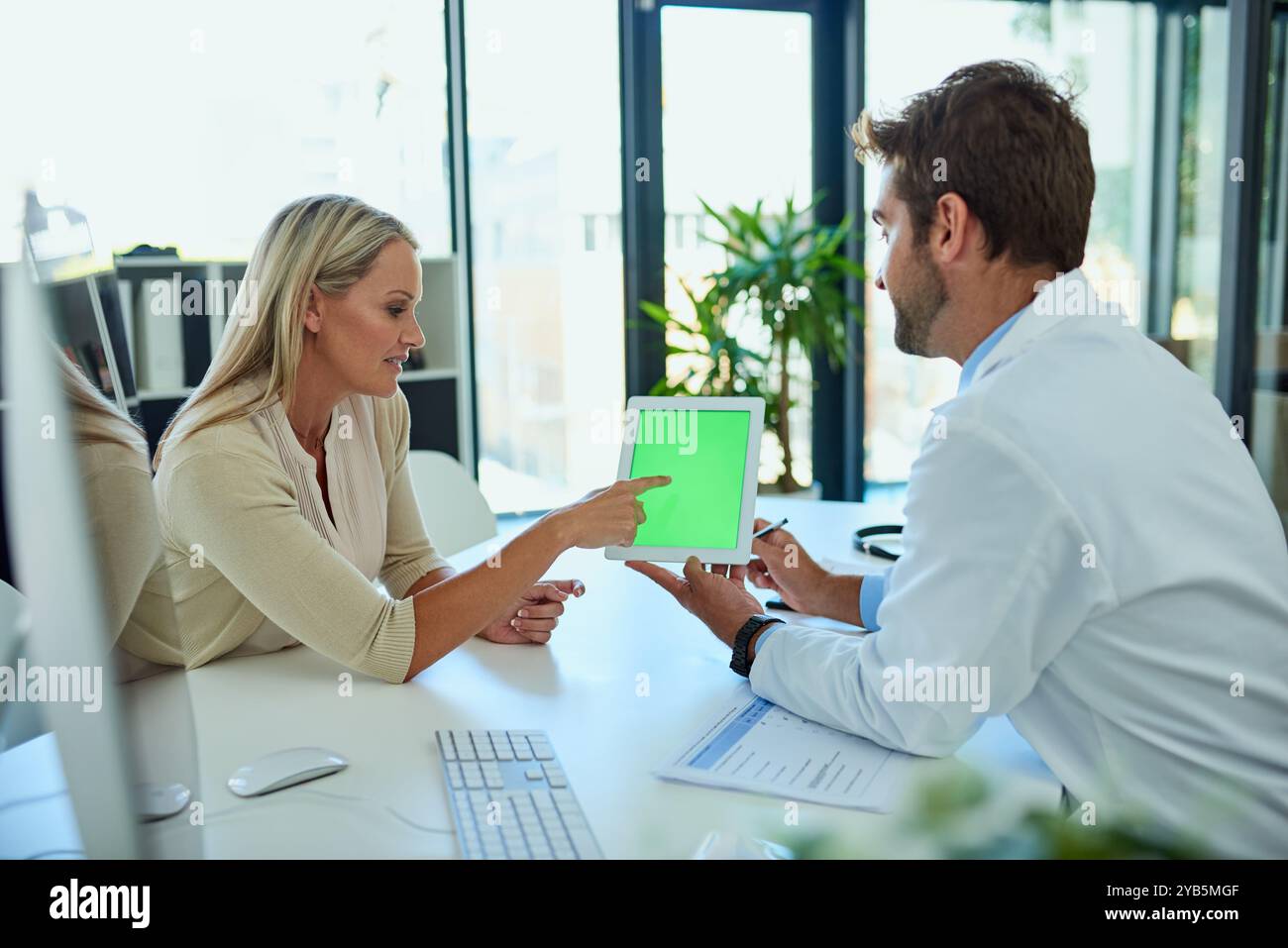 Doctor, woman and tablet green screen in consultation for patient test ...