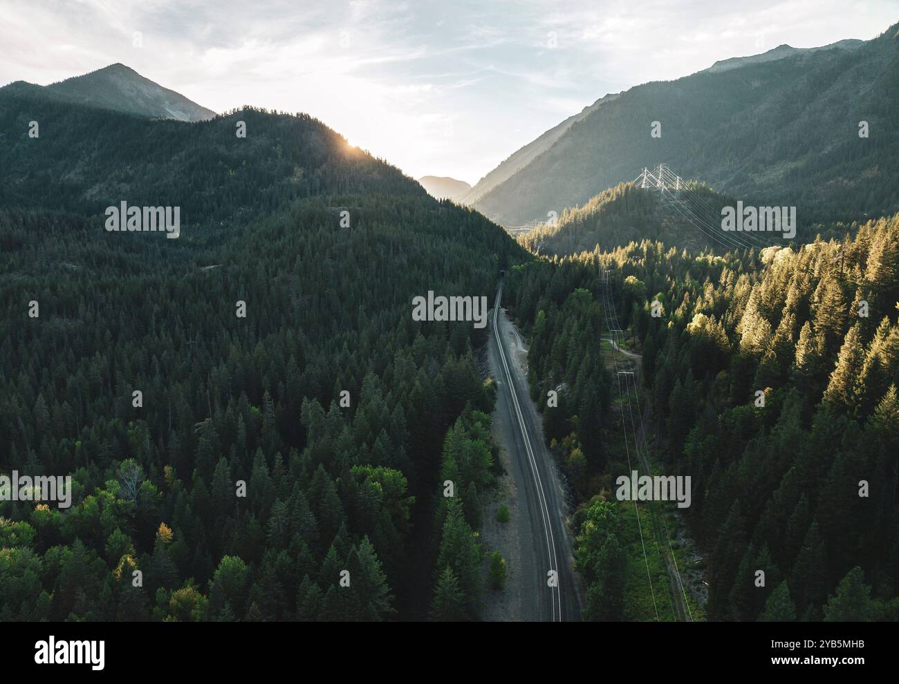 Aerial view of railroad tracks headed through the Cascades toward ...