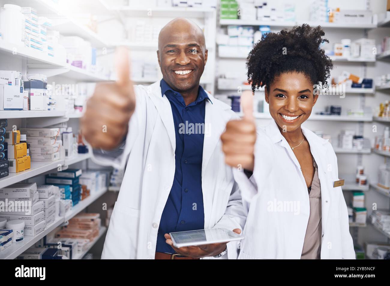 Pharmacy, portrait and doctors with tablet for thumbs up, approval and ...