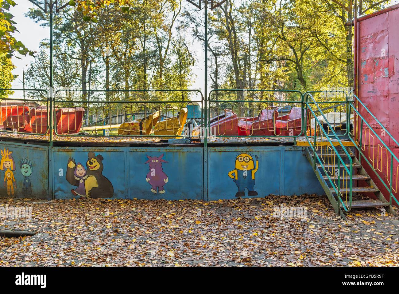 An old, rusty, abandoned amusement park. A faded carnival ride with ...