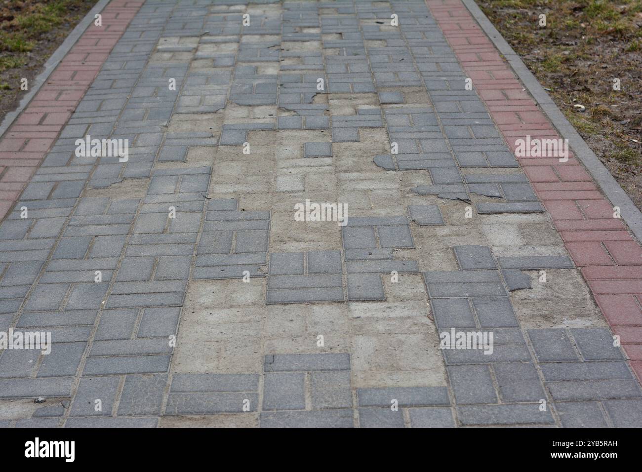 Broken pavement sidewalk in the garden. Damaged pavement need repair ...