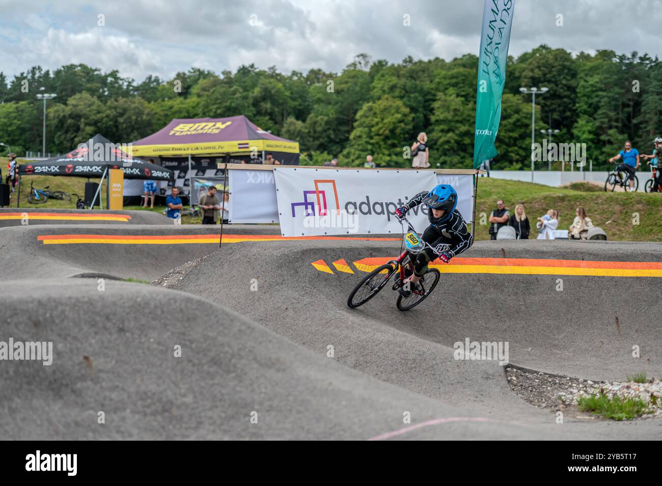 Tukums, Latvia - August 10, 2024: A boy rides his BMX bike on a pump ...