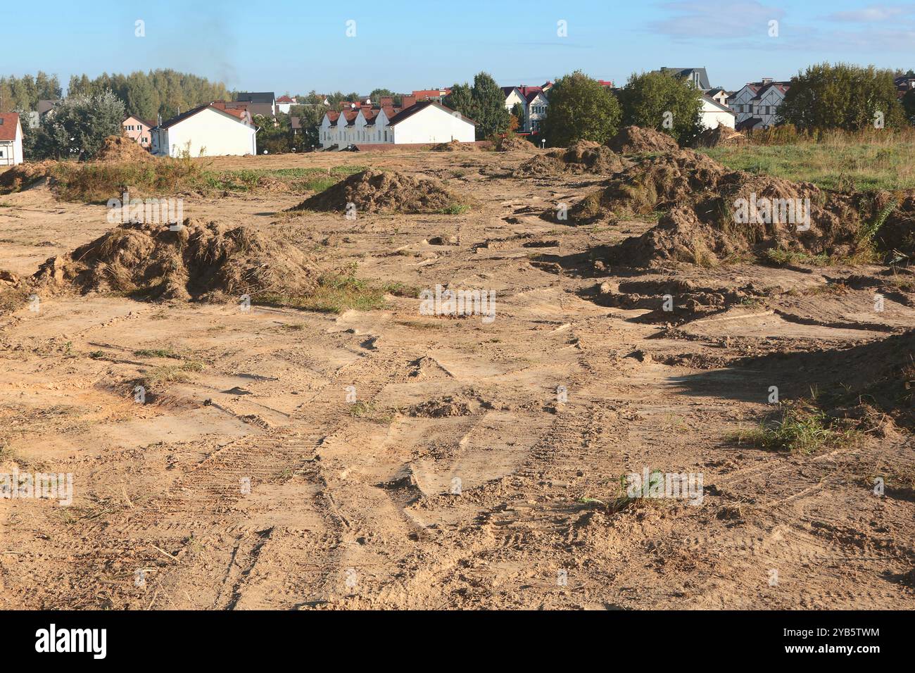 Leveling the ground for building new residential neighborhood. Heaps of ...